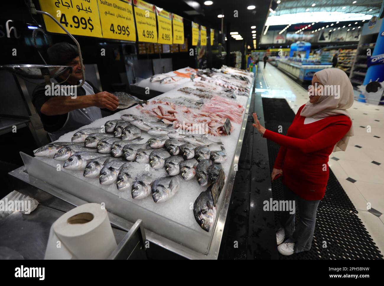 Beirut, Lebanon. 20th Mar, 2023. A woman buys fish in a supermarket in ...