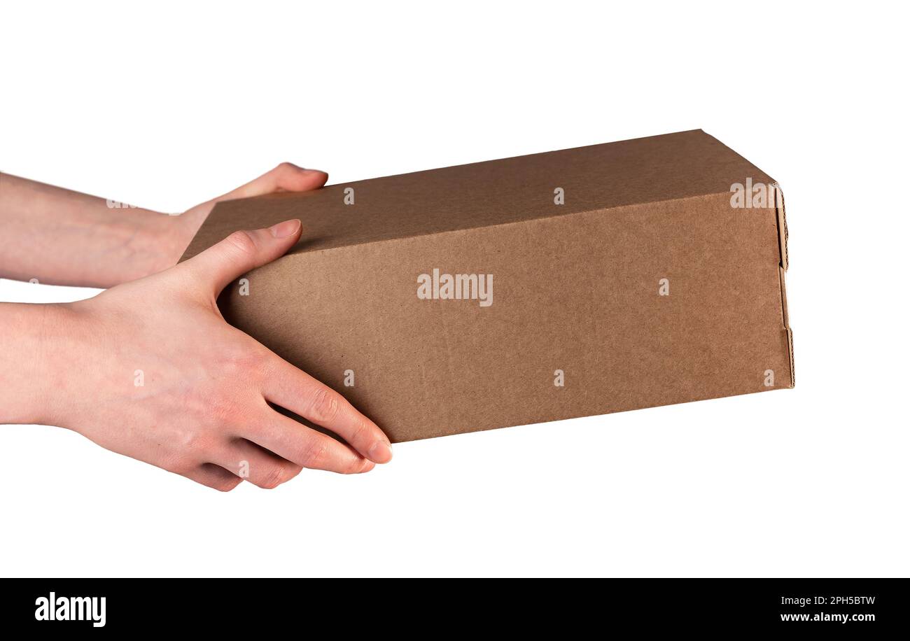 Hand holding cardboard box, giving carton package isolated on white ...