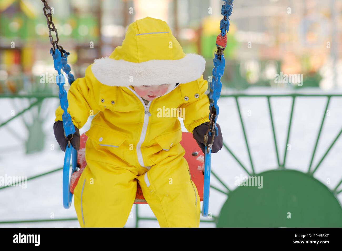 Toddler baby falls from a swing on the playground. A dangerous ...