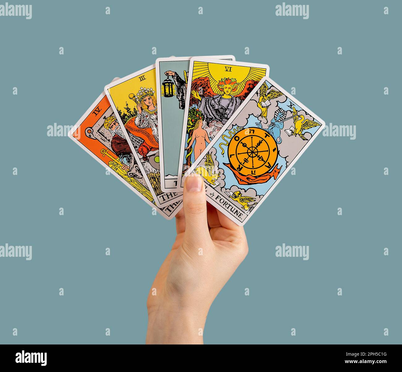 Hand holding tarot cards, major arcana. Fortune telling, divination ...