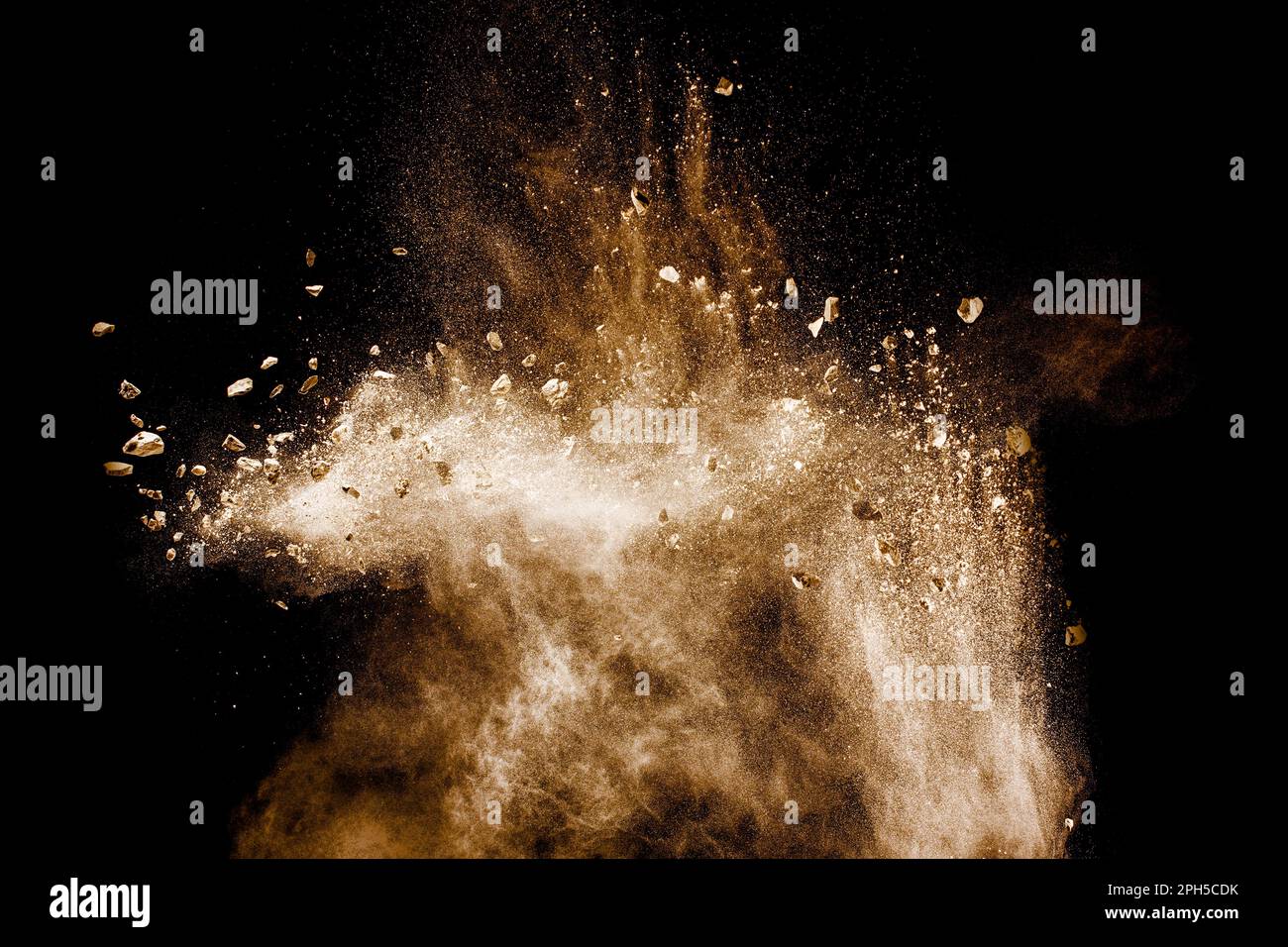 Split debris of stone exploding with brown powder against white ...
