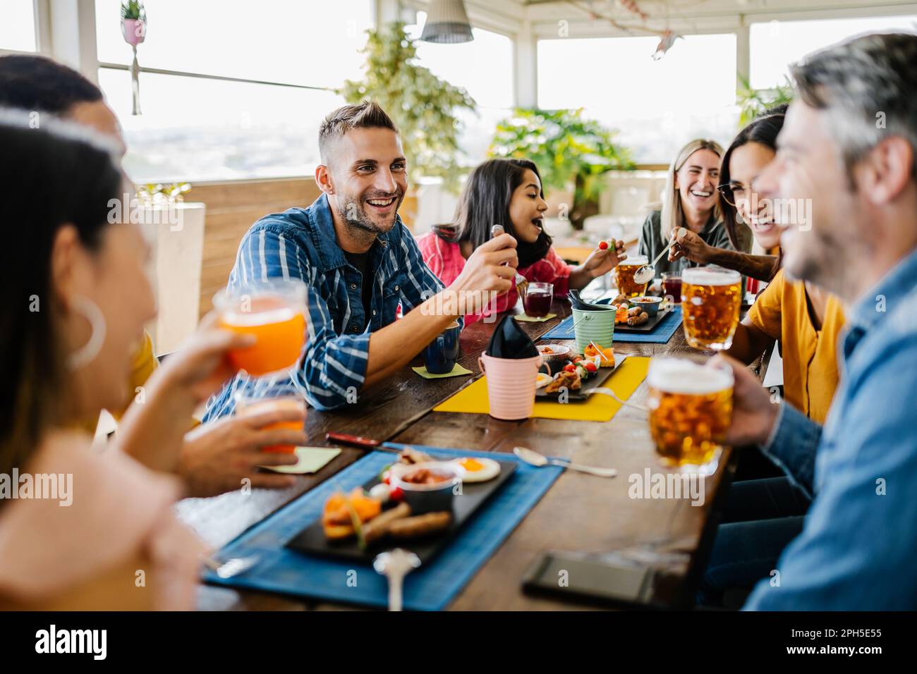Group of young student friends having lunch together in coffee shop ...