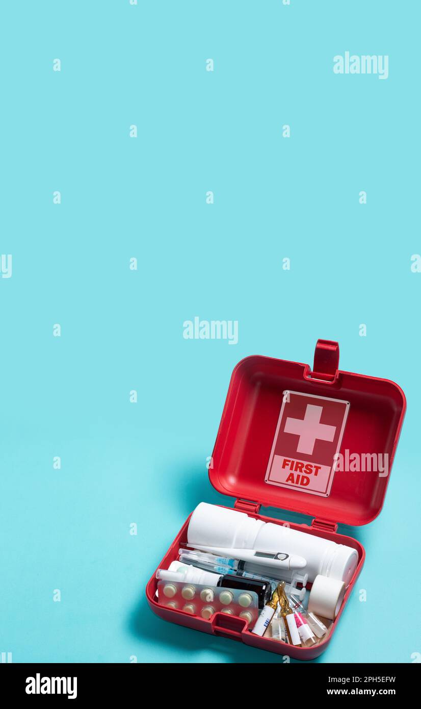 Home first aid kit on a blue background. The elements of the first aid ...