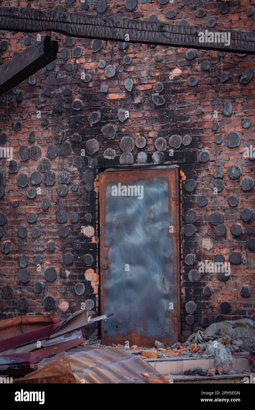 Burnt door of ruined house. Destroyed building after russian invasion ...