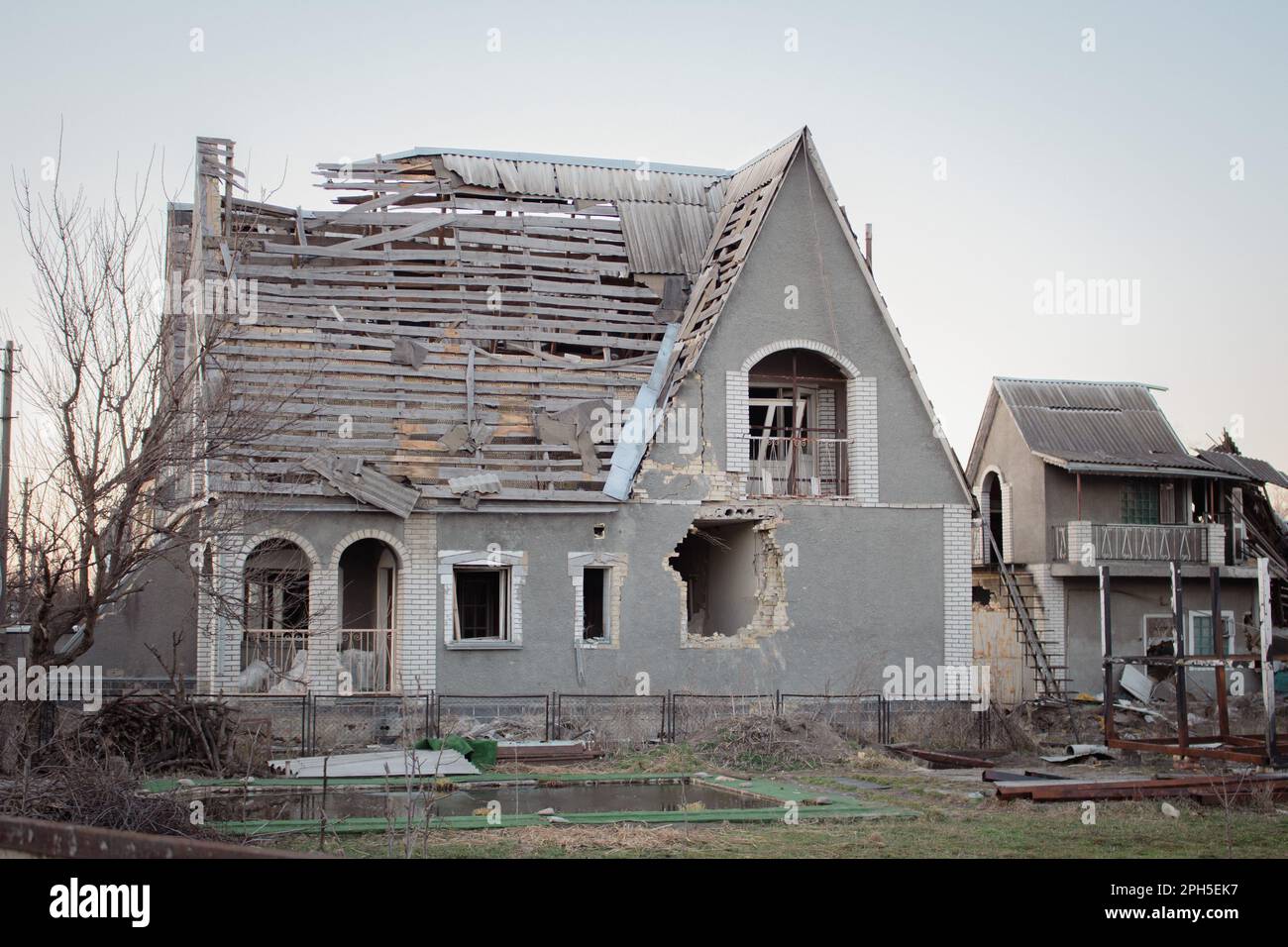 Destroyed building after russian invasion, Ukraine. Ruined facade of house. War in Ukraine ...