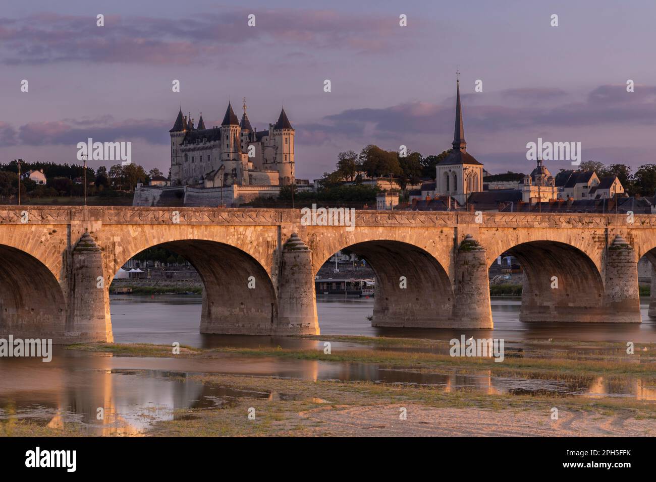 View over the Loire river during sunrise with the old bridge, the ...