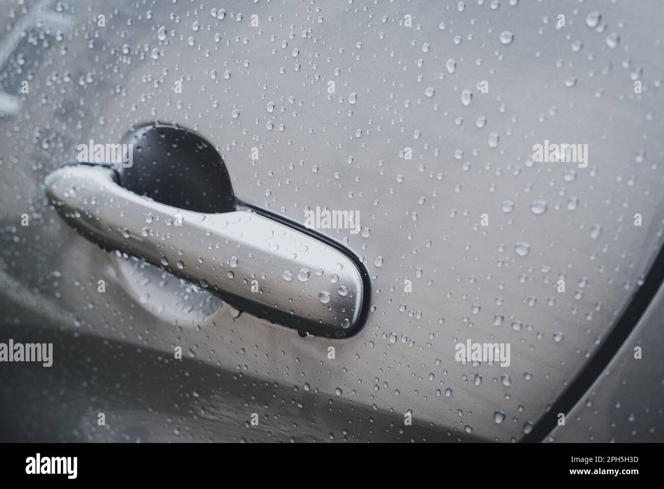 Close-up of a rear door handle seen on a hybrid city car. Taken after a ...