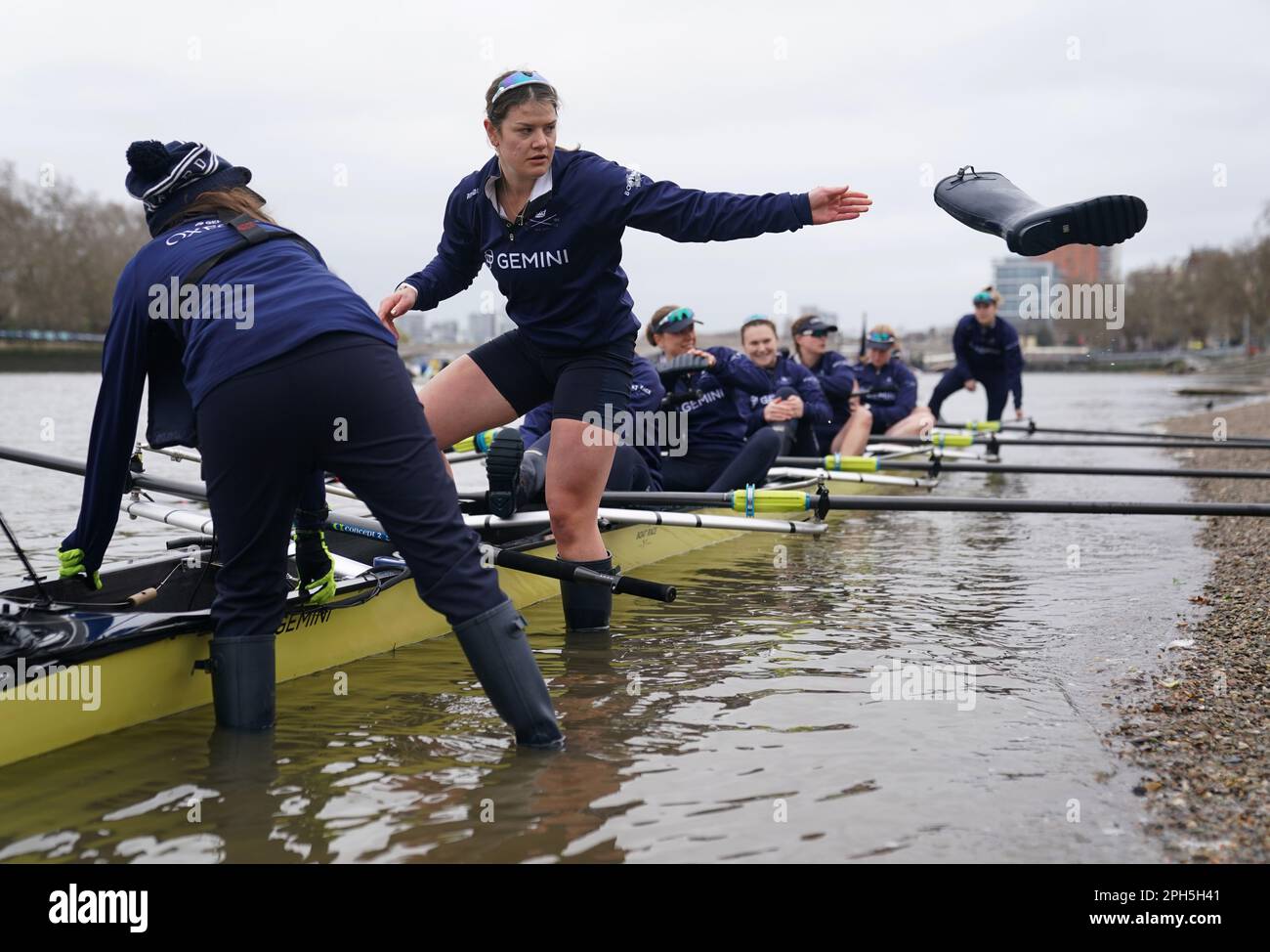 Oxford's Esther Austin throws her wellies from the boat before the ...