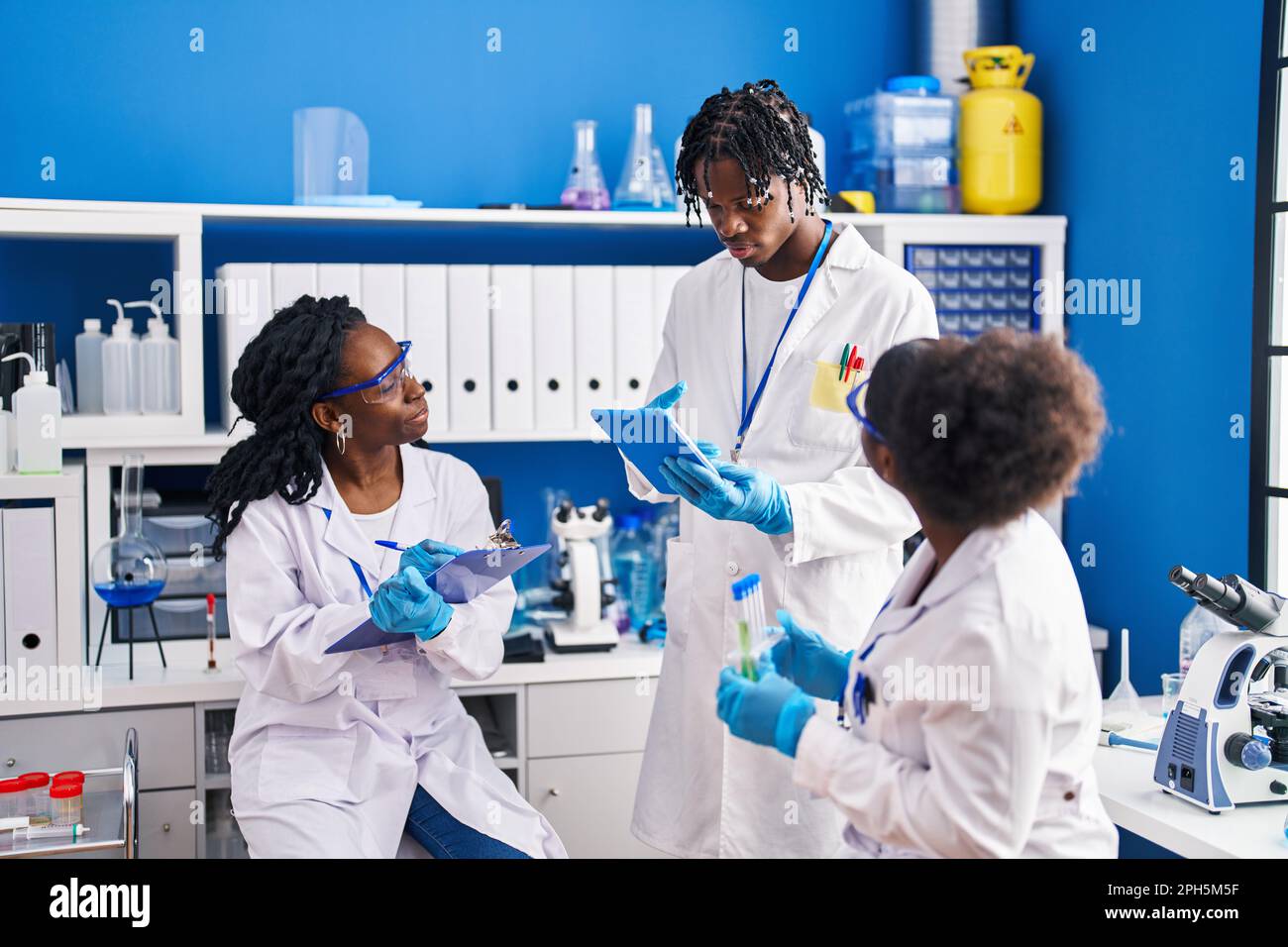 African american friends scientists using touchpad working at ...