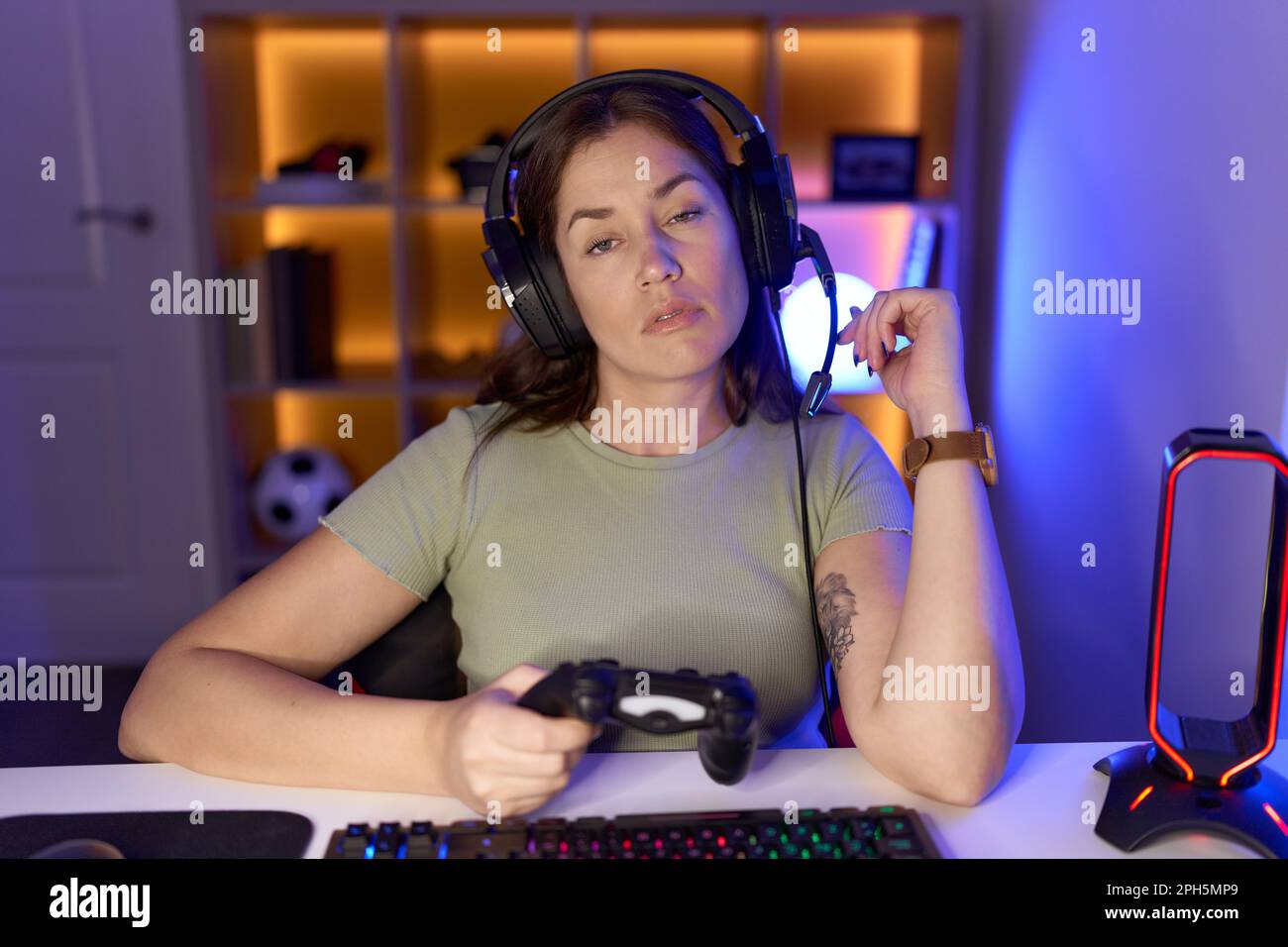 Tired female gamer playing video games hi-res stock photography and ...