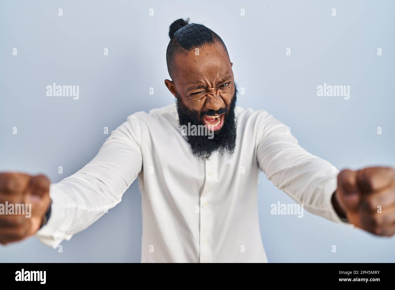 African american man standing over blue background angry and mad ...