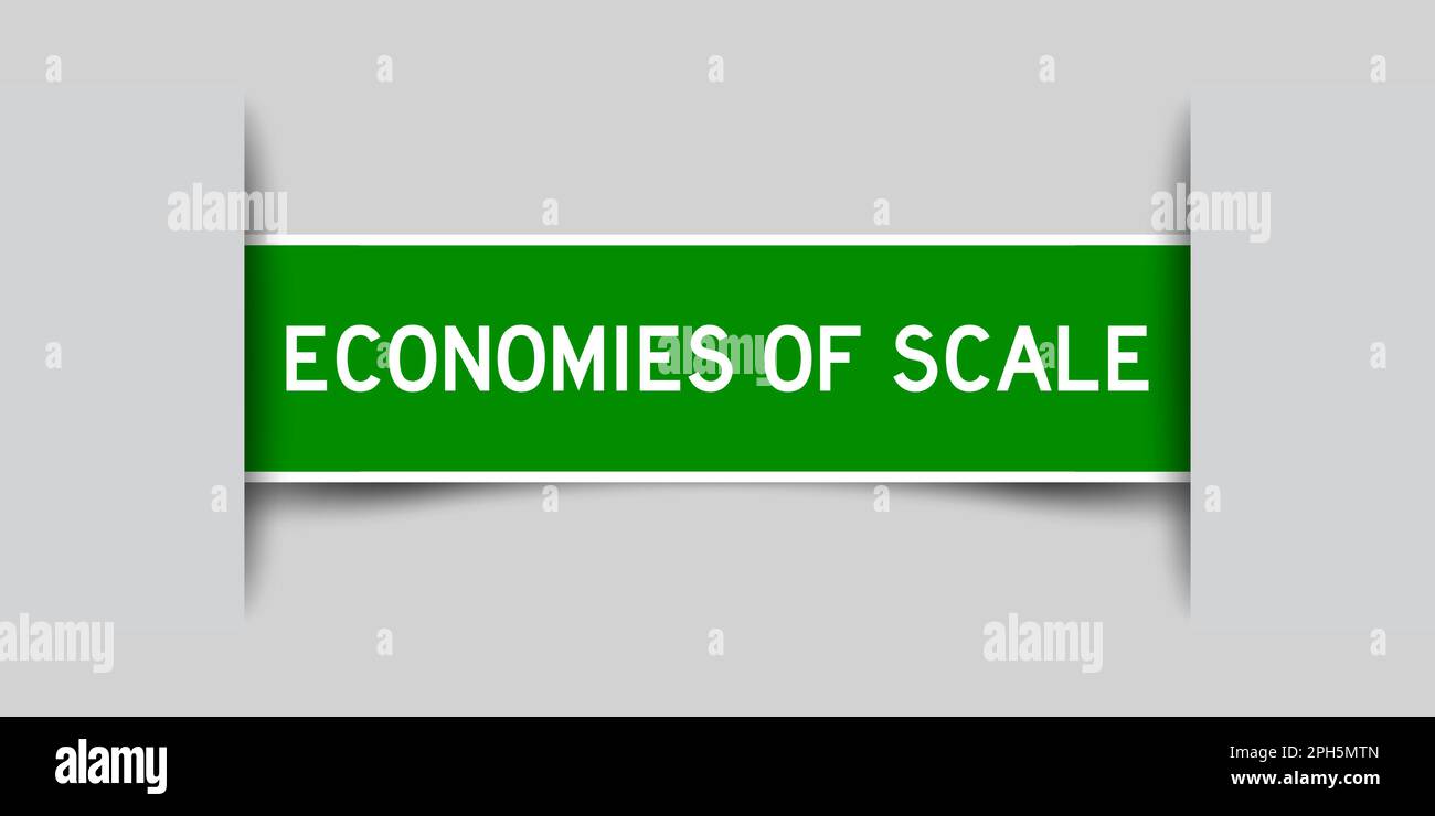 Inserted green color label sticker with word economies of scale on gray ...