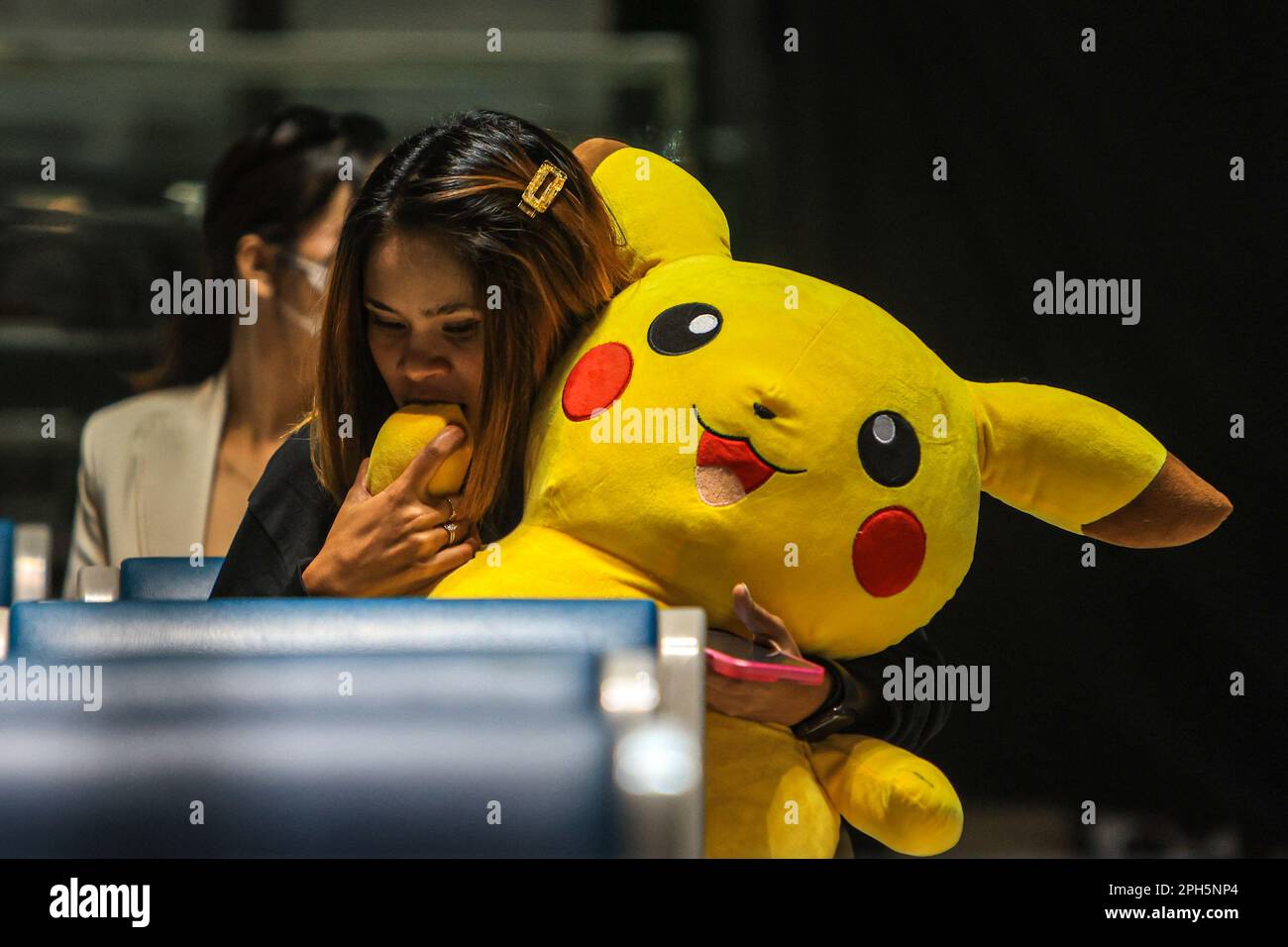 Manila, Manila, The Philippines. 26th Mar, 2023. A passenger bites a ...