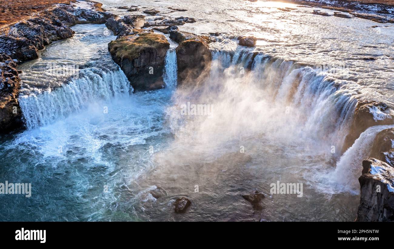 Godafoss waterfall in sunlight. High angle drone shot showing the width ...