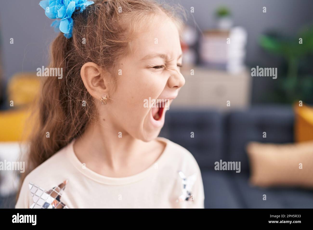 Adorable caucasian girl screaming at home Stock Photo - Alamy
