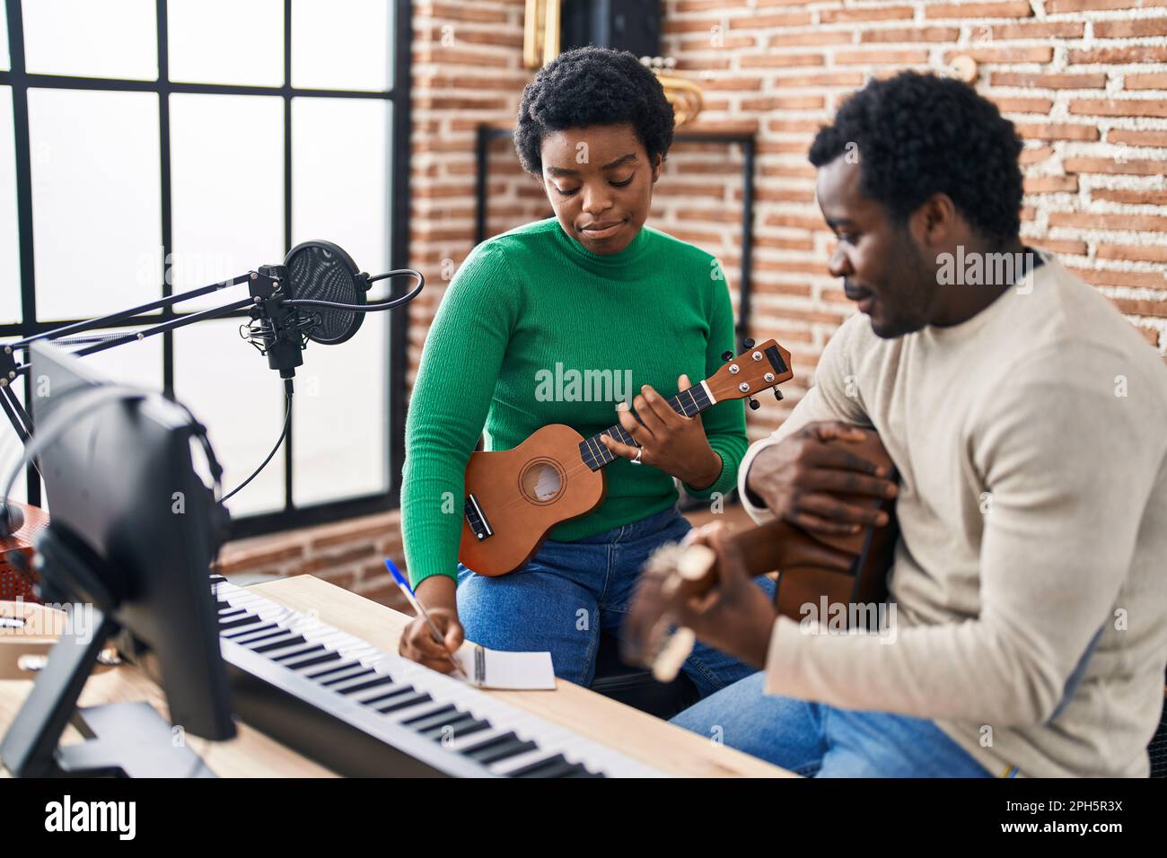African american man and woman music group compising song at music ...