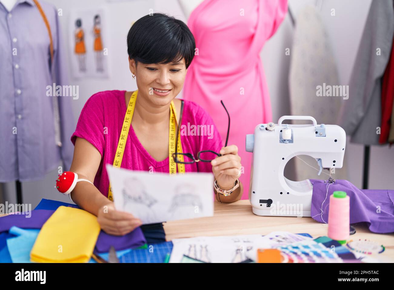 Middle age chinese woman tailor smiling confident looking clothing ...