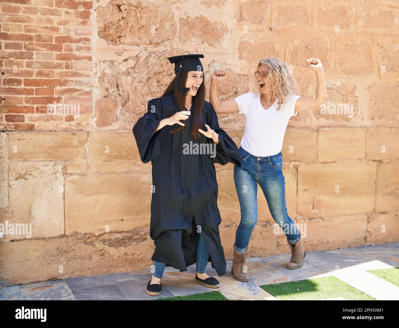 Two Women Mother And Graduated Daughter Standing Together At Campus