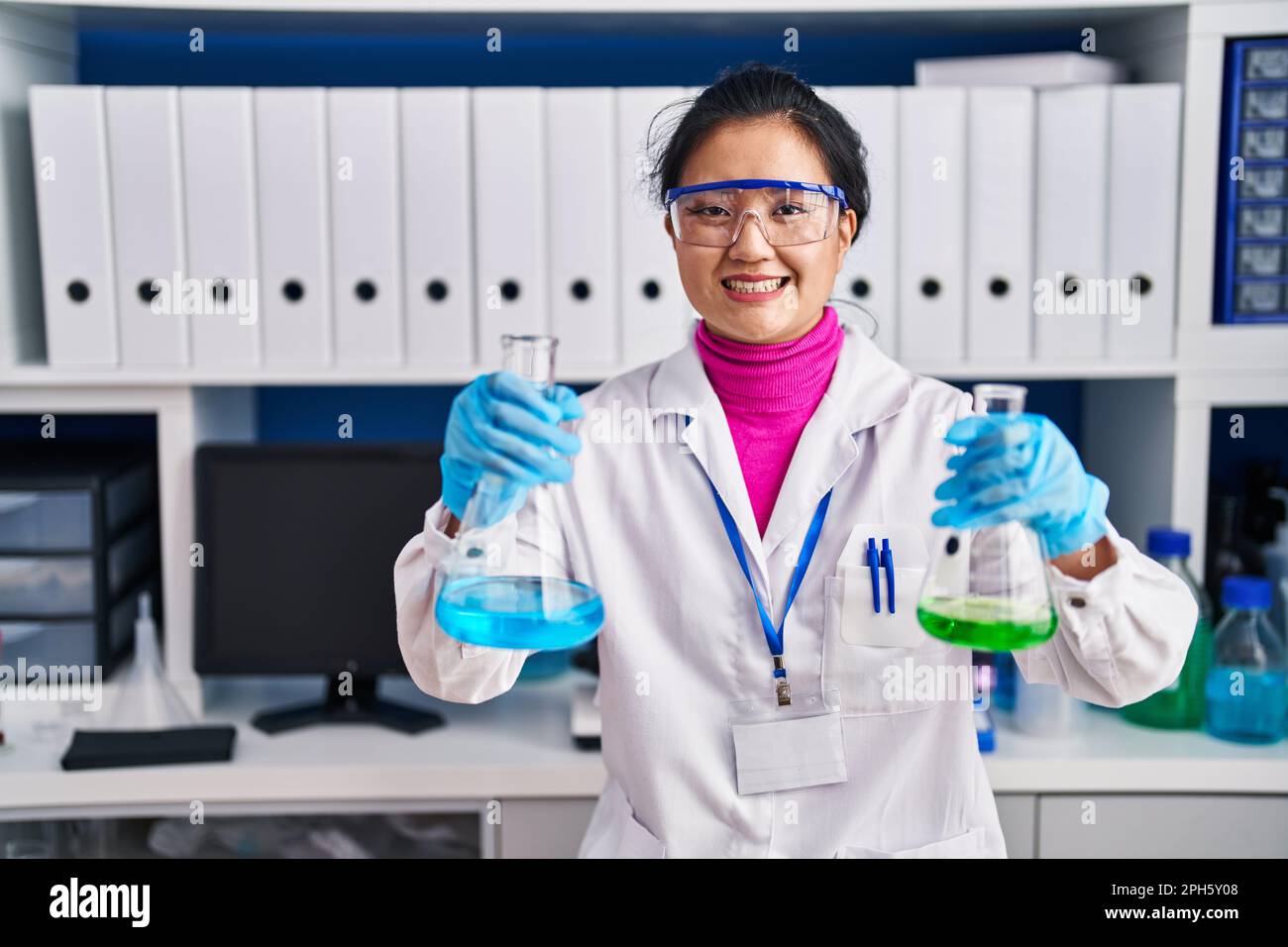 Young asian woman working at scientist laboratory smiling with a happy ...