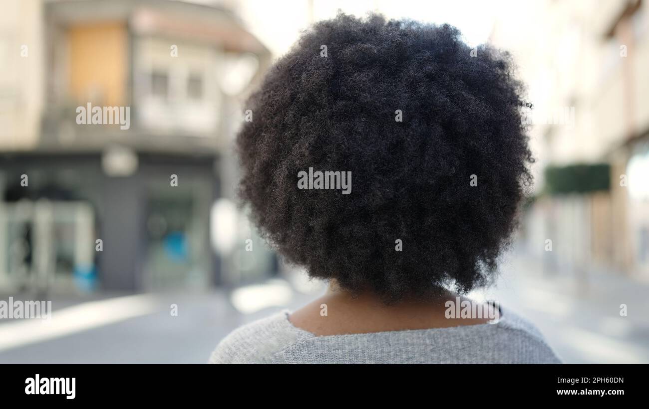 African american woman standing on back view at street Stock Photo - Alamy