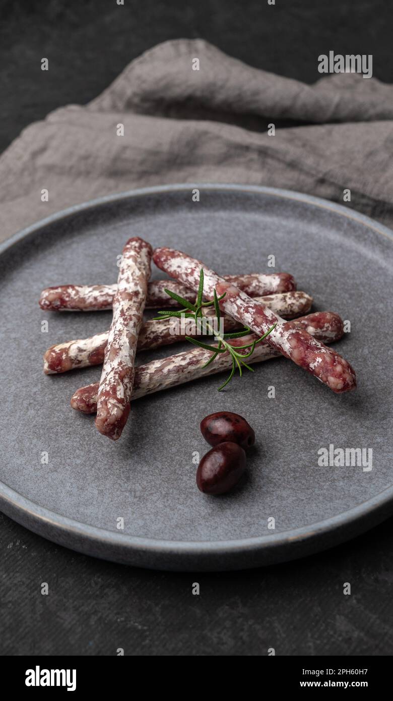 Close-up of Spanish mini fuet on the grey plate Stock Photo - Alamy