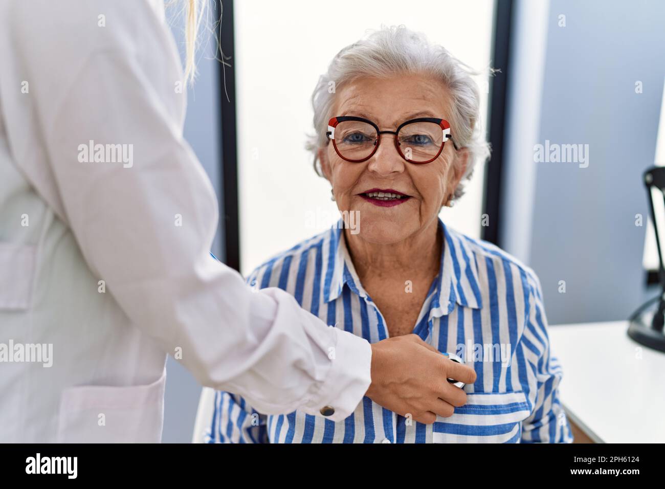 Senior grey-haired woman patient having medical consultation ...