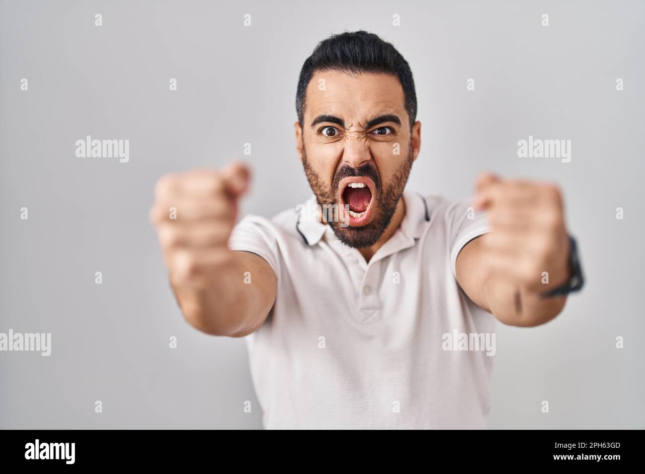 Young hispanic man with beard wearing casual clothes over white ...