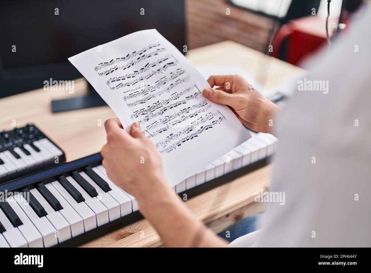 Young arab man musician reading music sheet at music studio Stock Photo ...