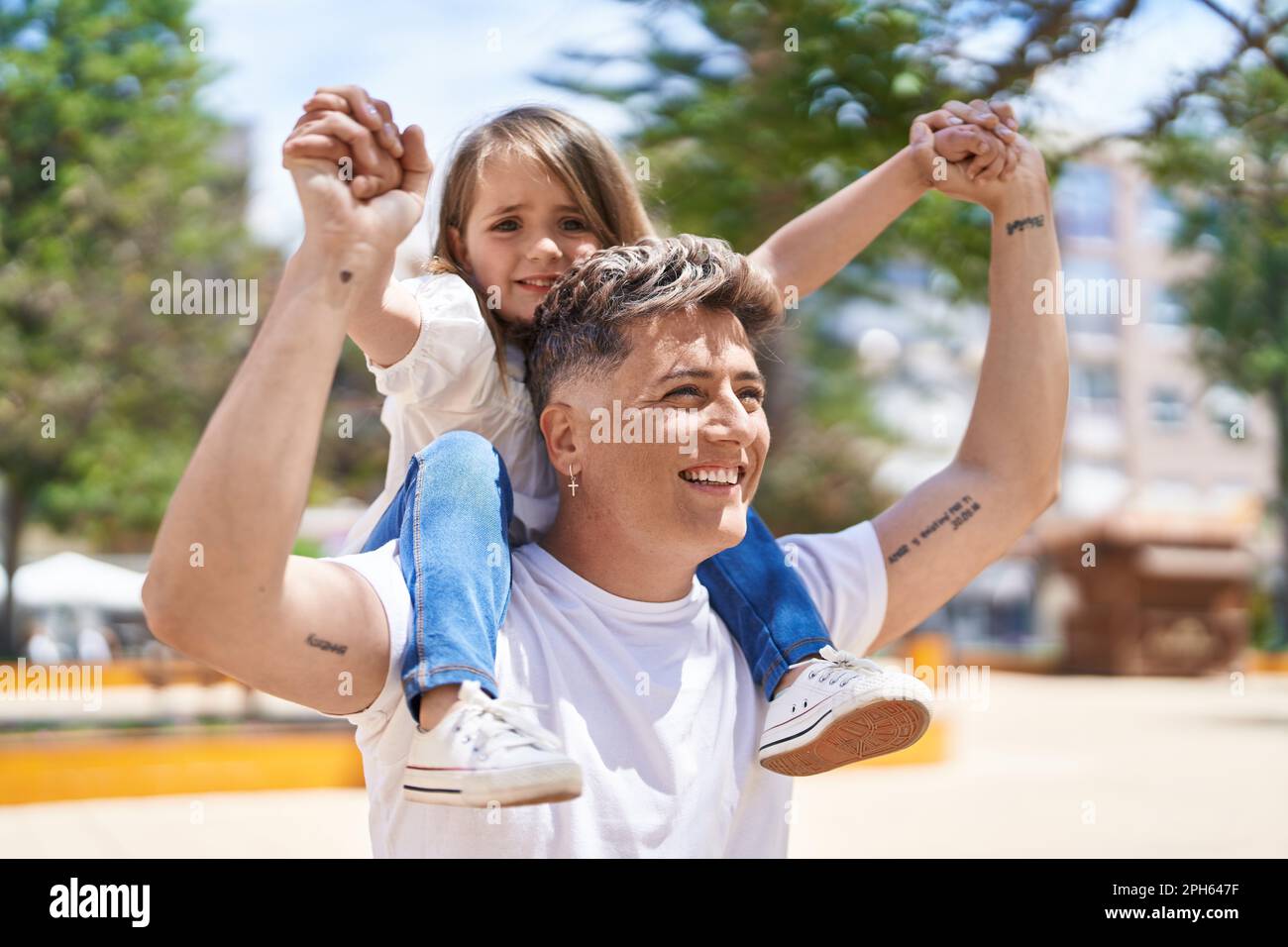 Father and daughter smiling confident hugging each other holding on back at park Stock Photo - Alamy