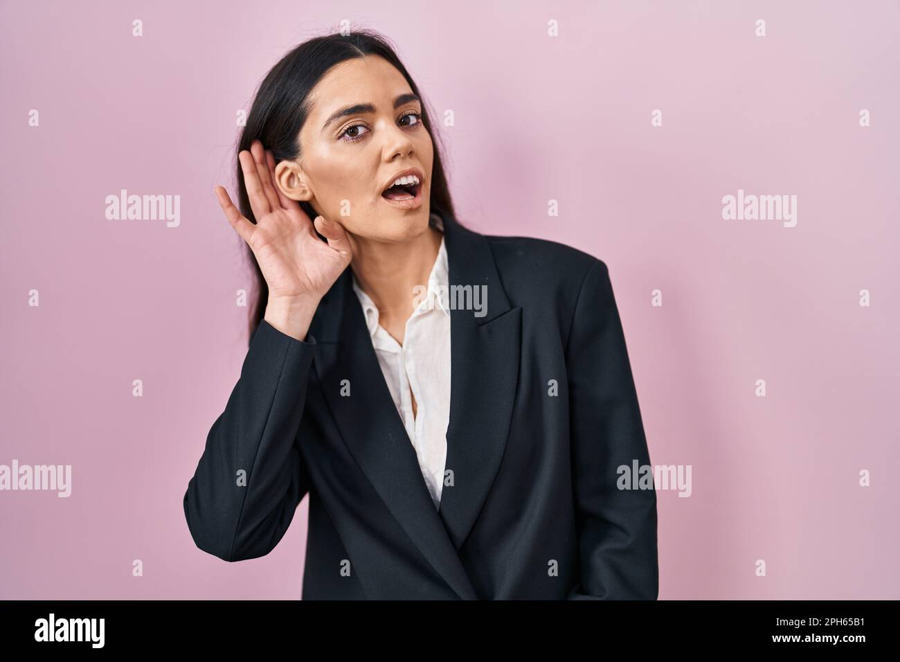 Young brunette woman wearing business style over pink background ...