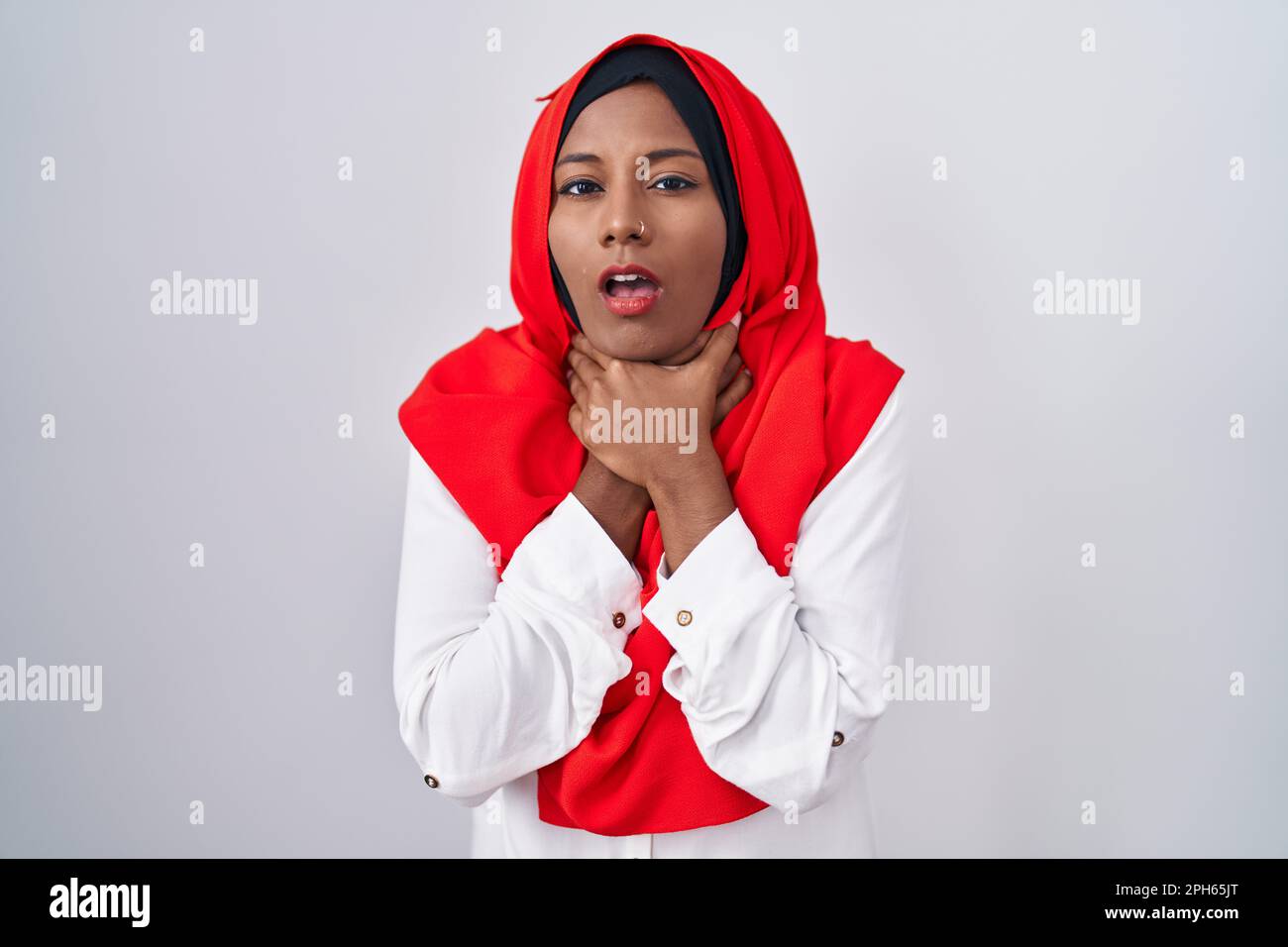 Young arab woman wearing traditional islamic hijab scarf shouting ...