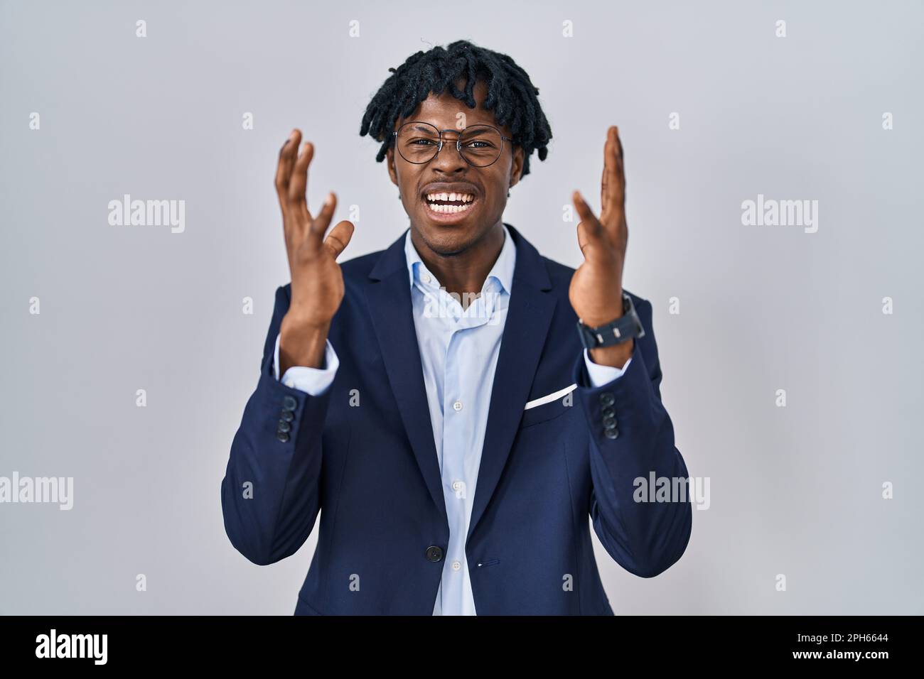 Young african man with dreadlocks wearing business jacket over white ...