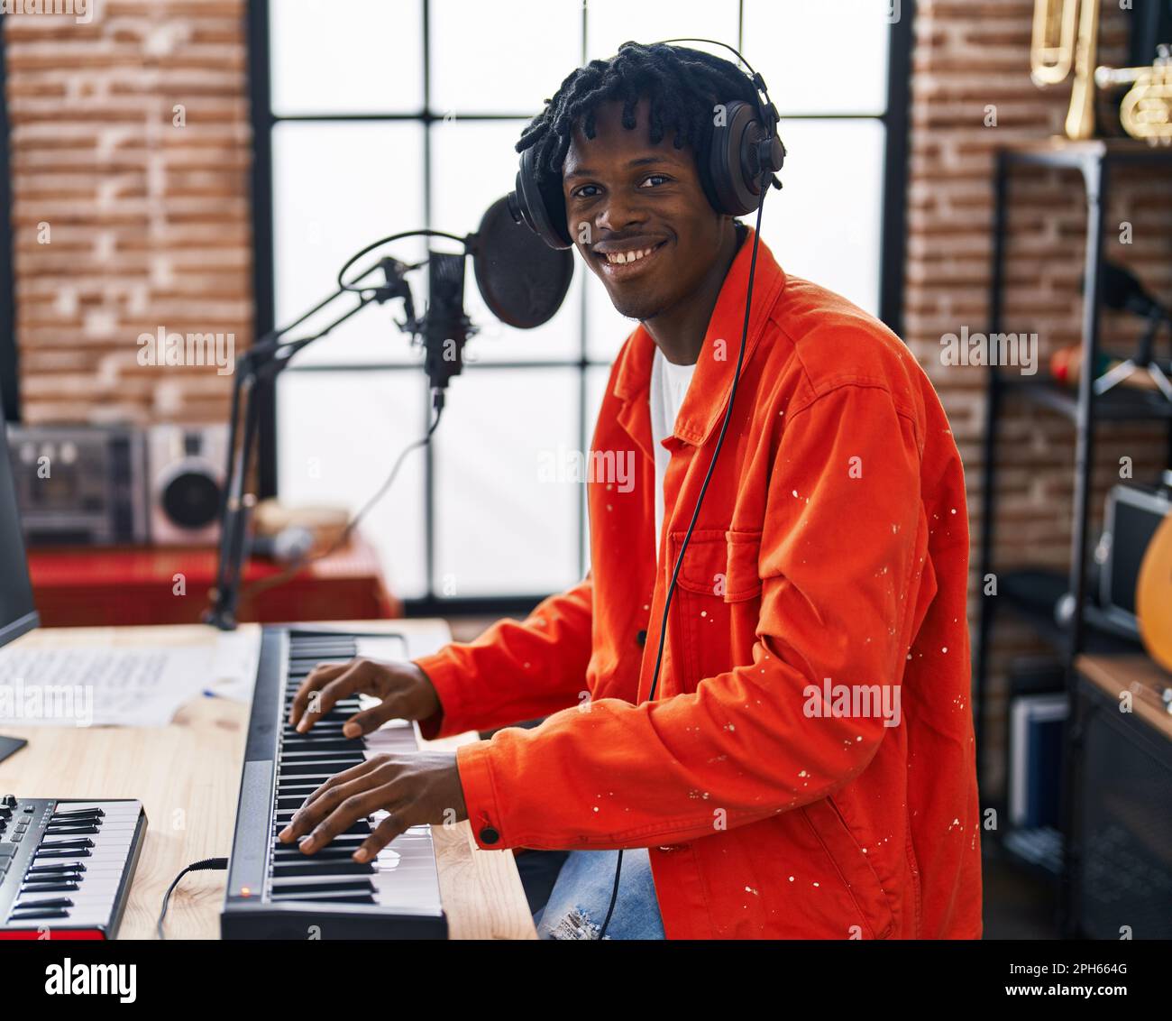 African american man musician playing piano keyboard at music studio ...