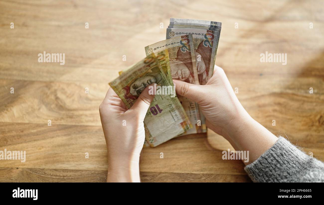 Hands of woman counting peruvian soles banknotes at room Stock Photo ...