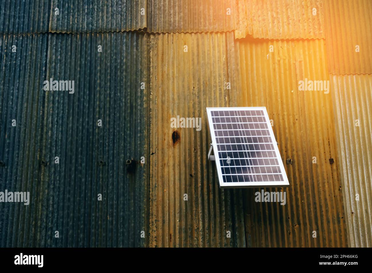 Solar panel attached on old zinc wall. Electric solar panel on the ...