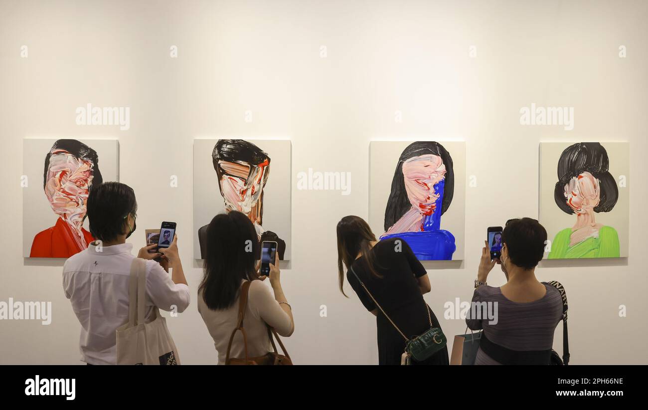 Visitors admiring artworks (L-R) Painting of Painting 040; Painting of ...