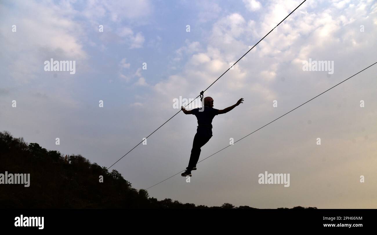 Guwahati, Guwahati, India. 24th Mar, 2023. A youth travel in Zip line ...