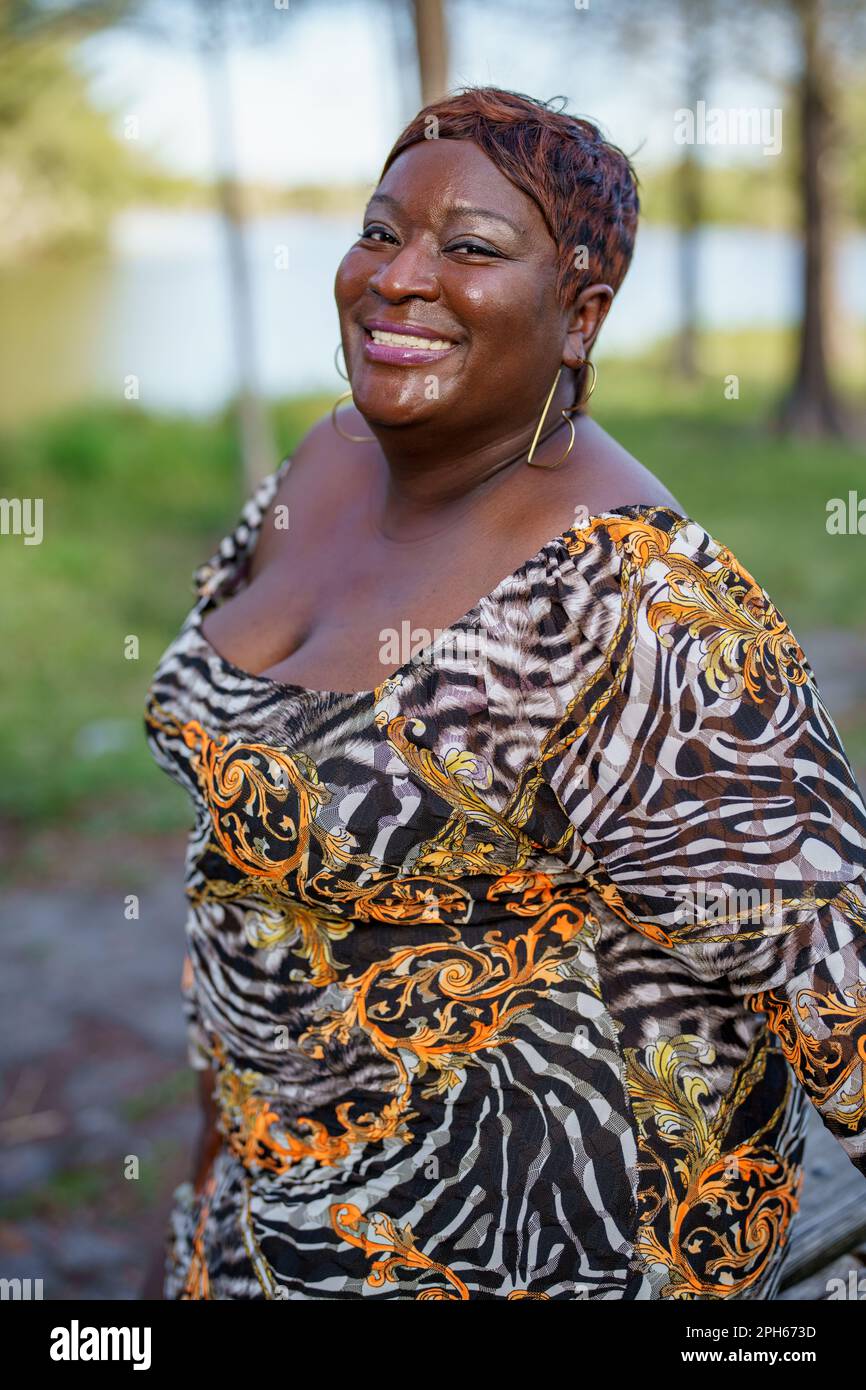 Attractive adult plus size model posing in the park Stock Photo - Alamy