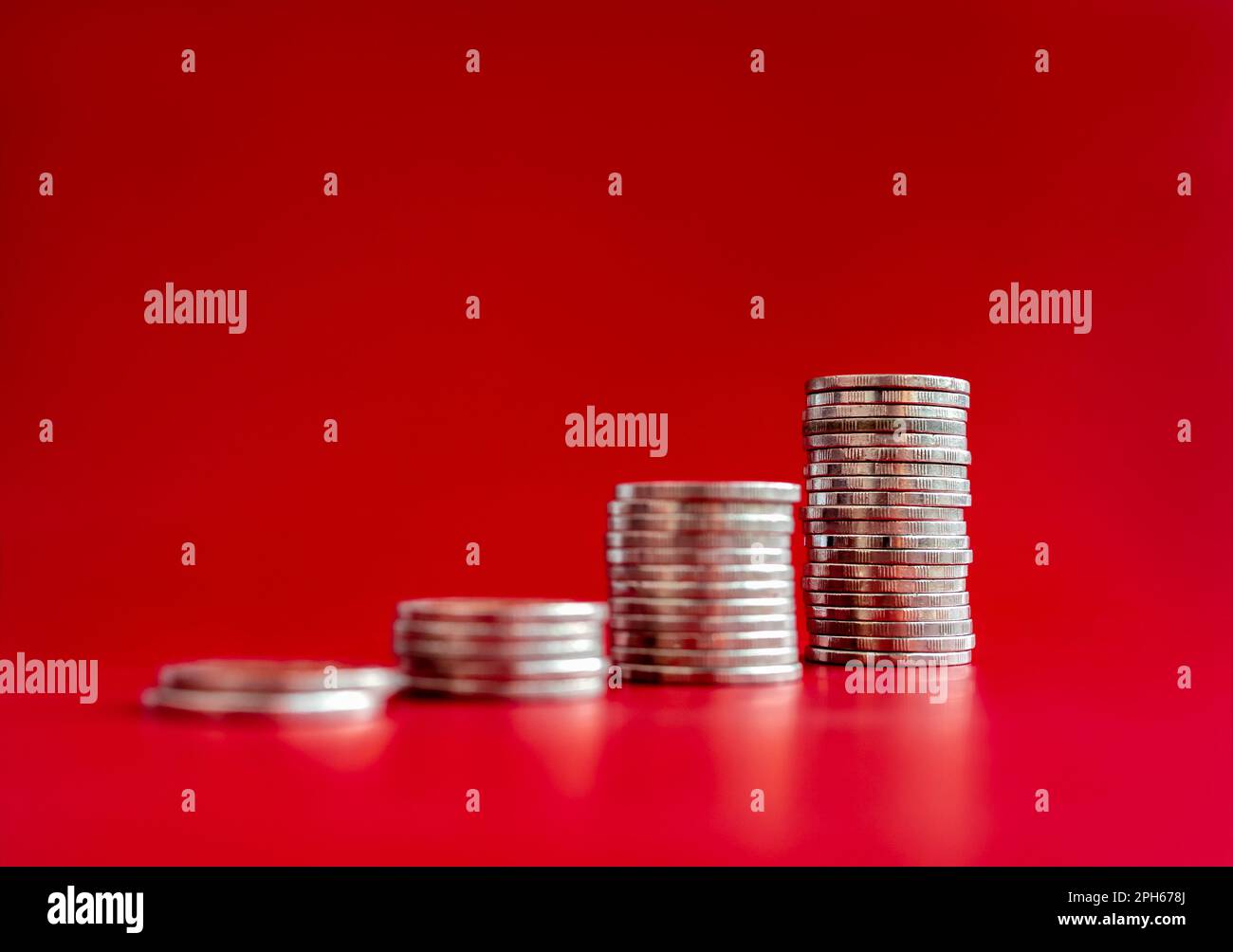 Focus on the highest coin stacks as graph chart steps isolated on red ...