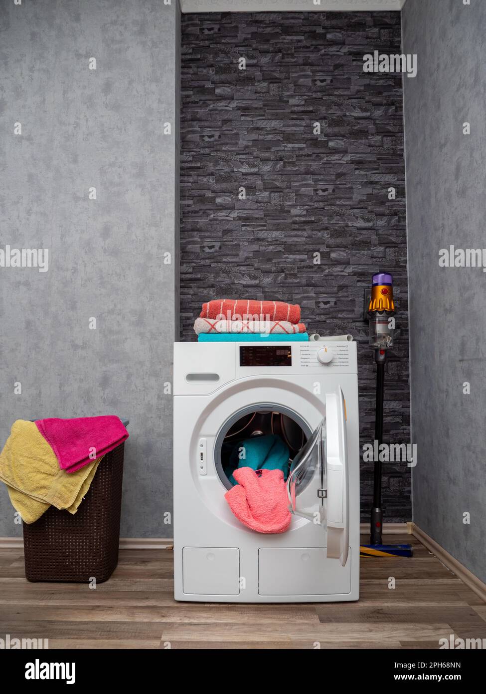 Laundry room interior with washing machine against the wall. Modern ...