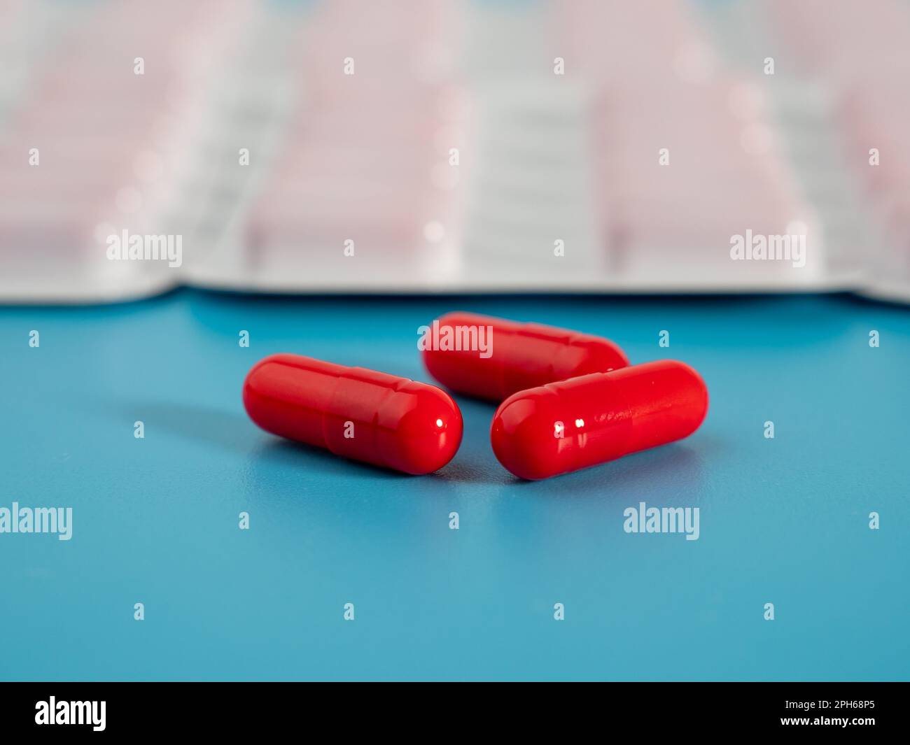 Red medical capsules. Capsules in a blister pack. Close-up Stock Photo ...