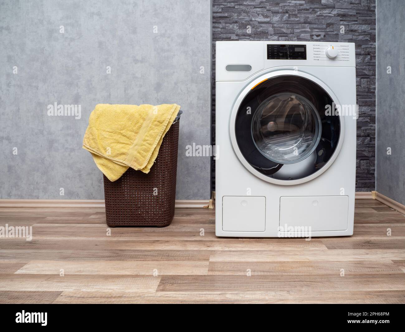 Laundry room interior with washing machine against the wall. Modern ...
