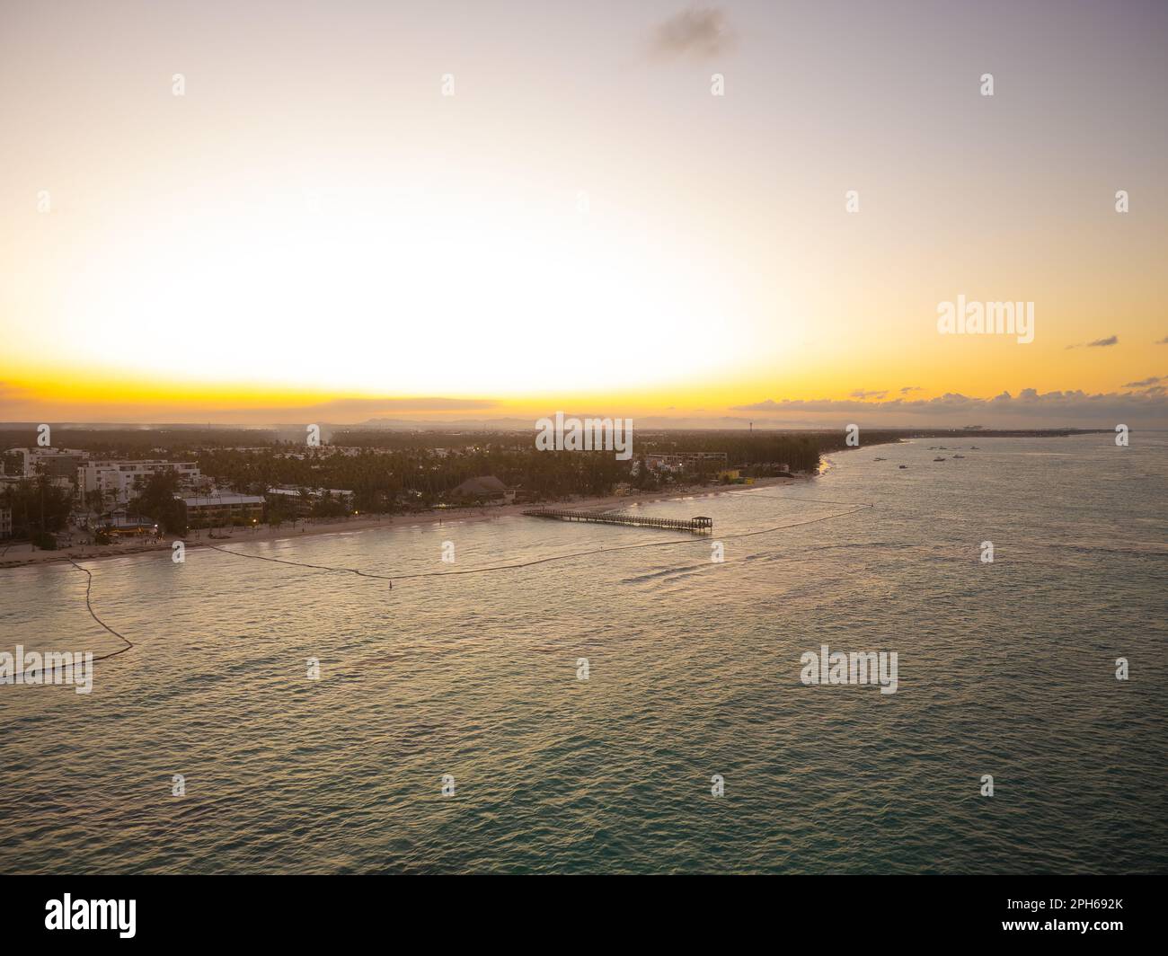 Small town by the sea. Wooden bridge in the water. Twilight. Beautiful ...
