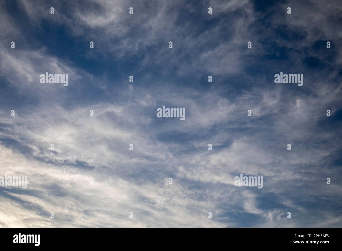 Detail of intense blue sky in broad daylight with fluffy white cirrus ...