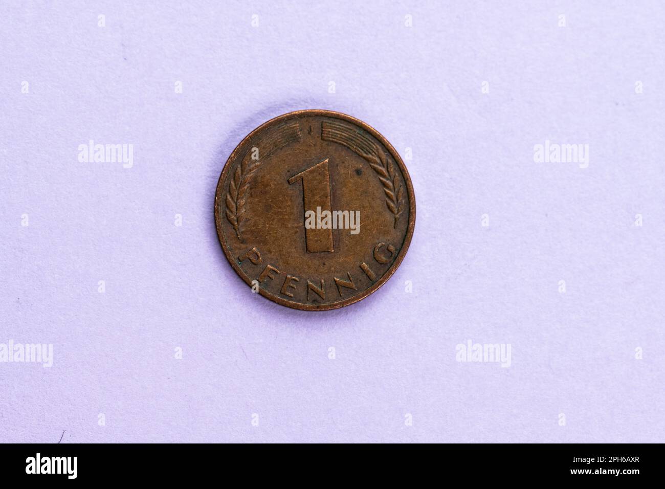 One german Pfennig coin on purple background Stock Photo - Alamy