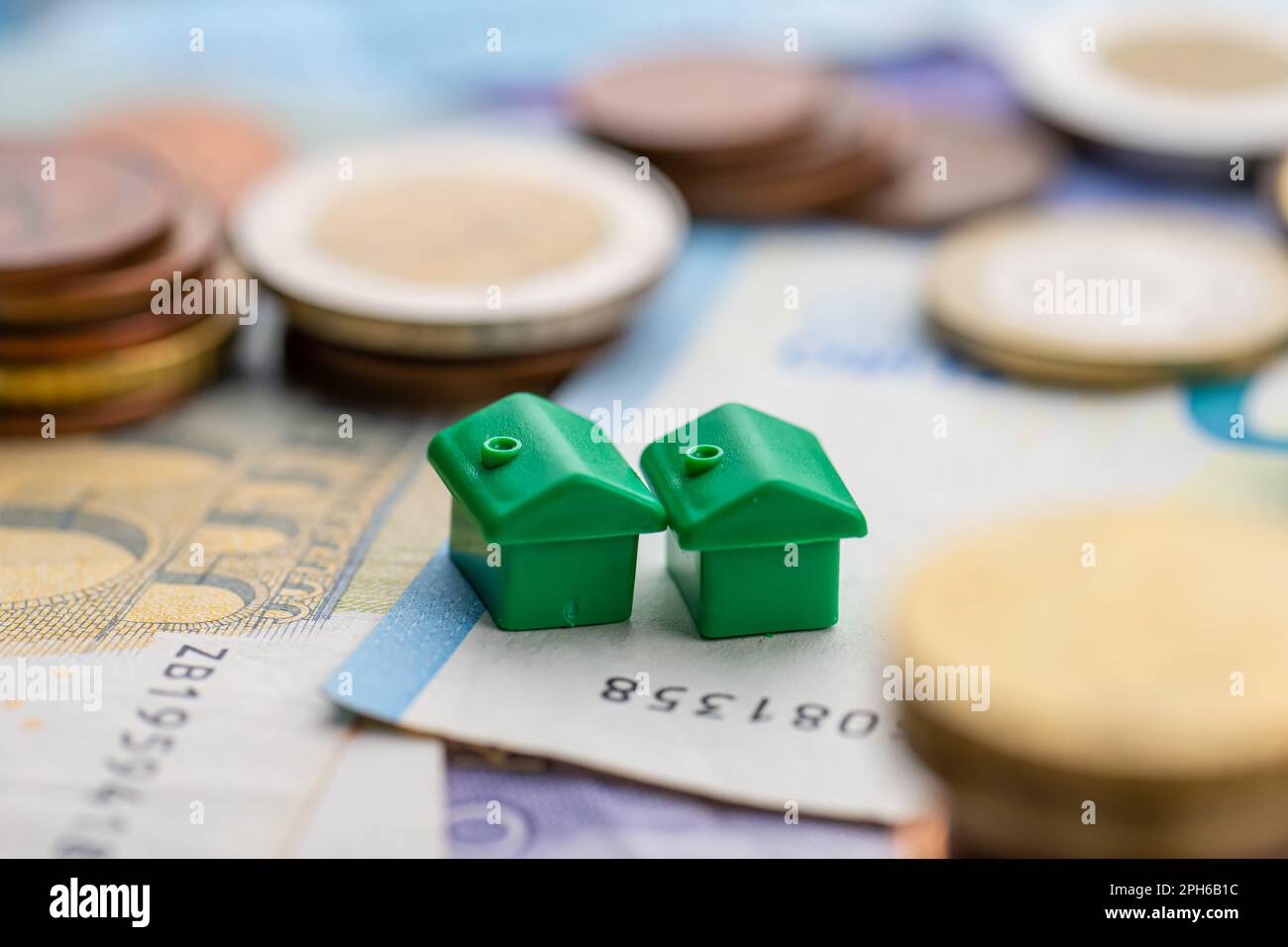 Small house by stacks of coins representing house financing Stock Photo ...