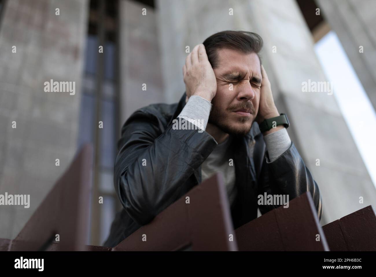 sad man holding his head and worrying Stock Photo - Alamy