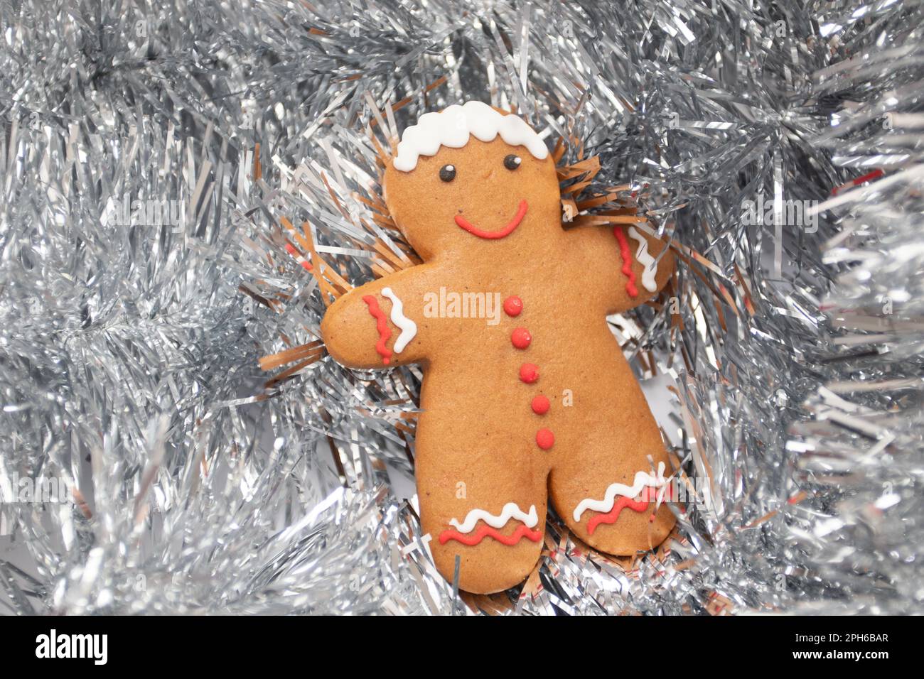 Gingerbread man in shiny silver tinsel Stock Photo - Alamy