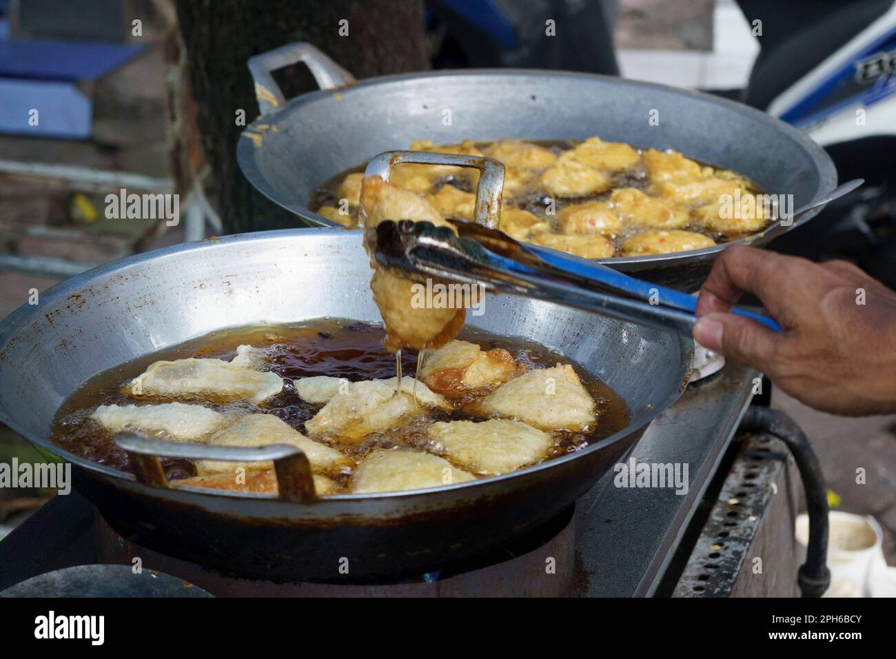 Pan Frying process of the Indonesian street vendors for the meals as ...
