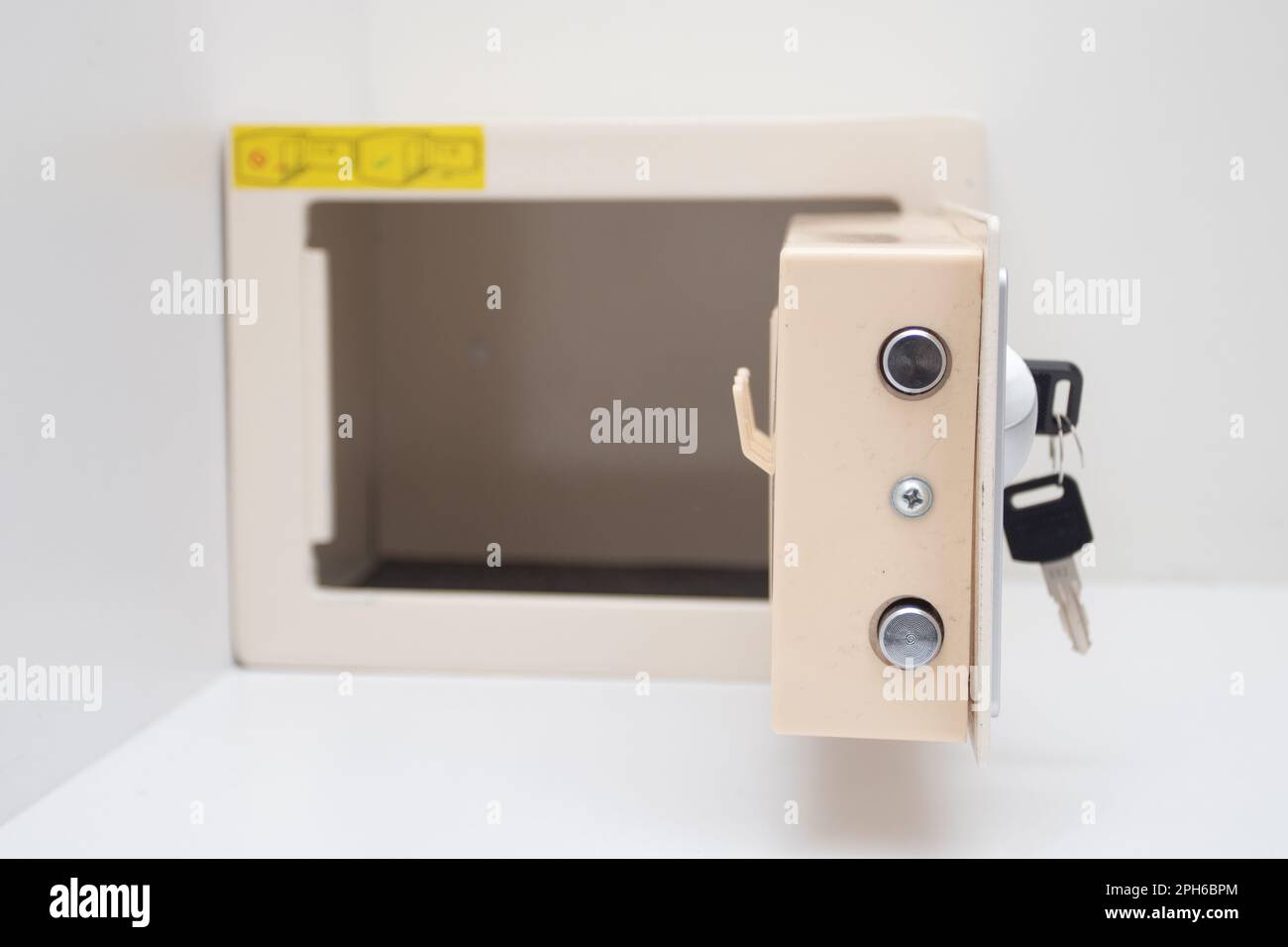 Open mini safe box with keys on white background Stock Photo - Alamy